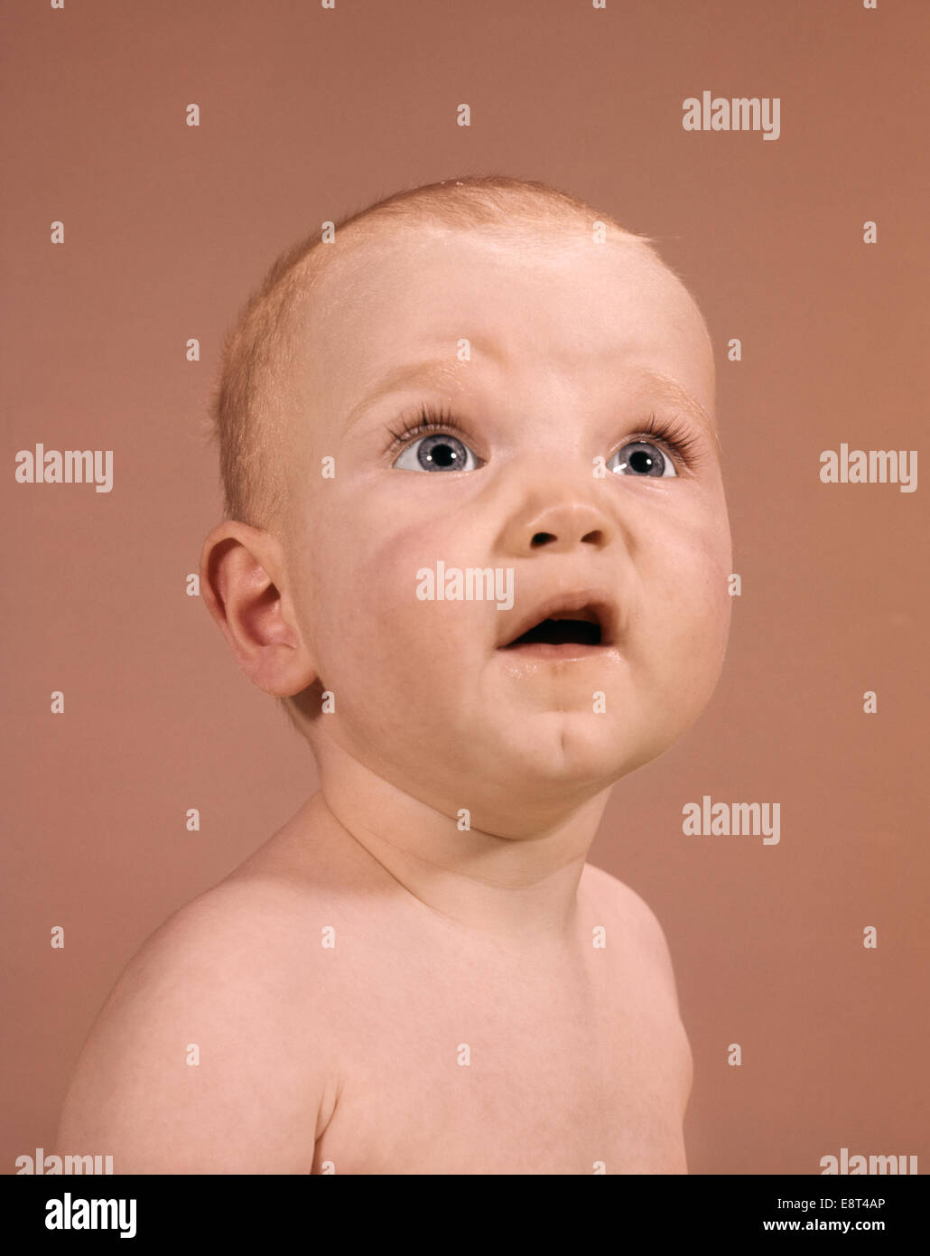 1960s BABY PORTRAIT LOOKING UP UNCERTAIN FACIAL EXPRESSION Stock Photo ...