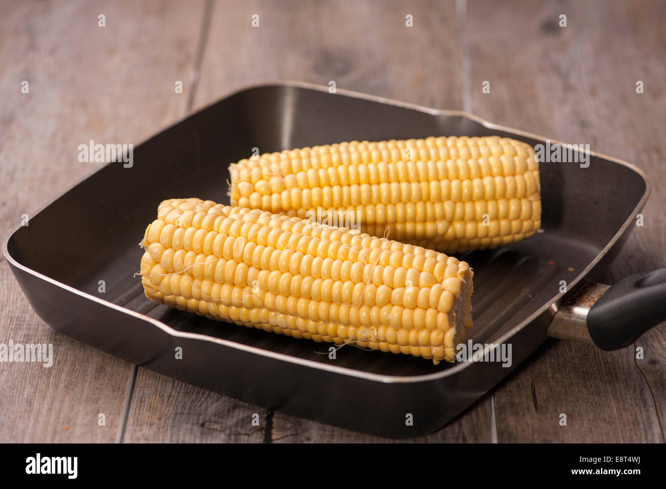 two corn on the cobs ready to be cooked Stock Photo - Alamy
