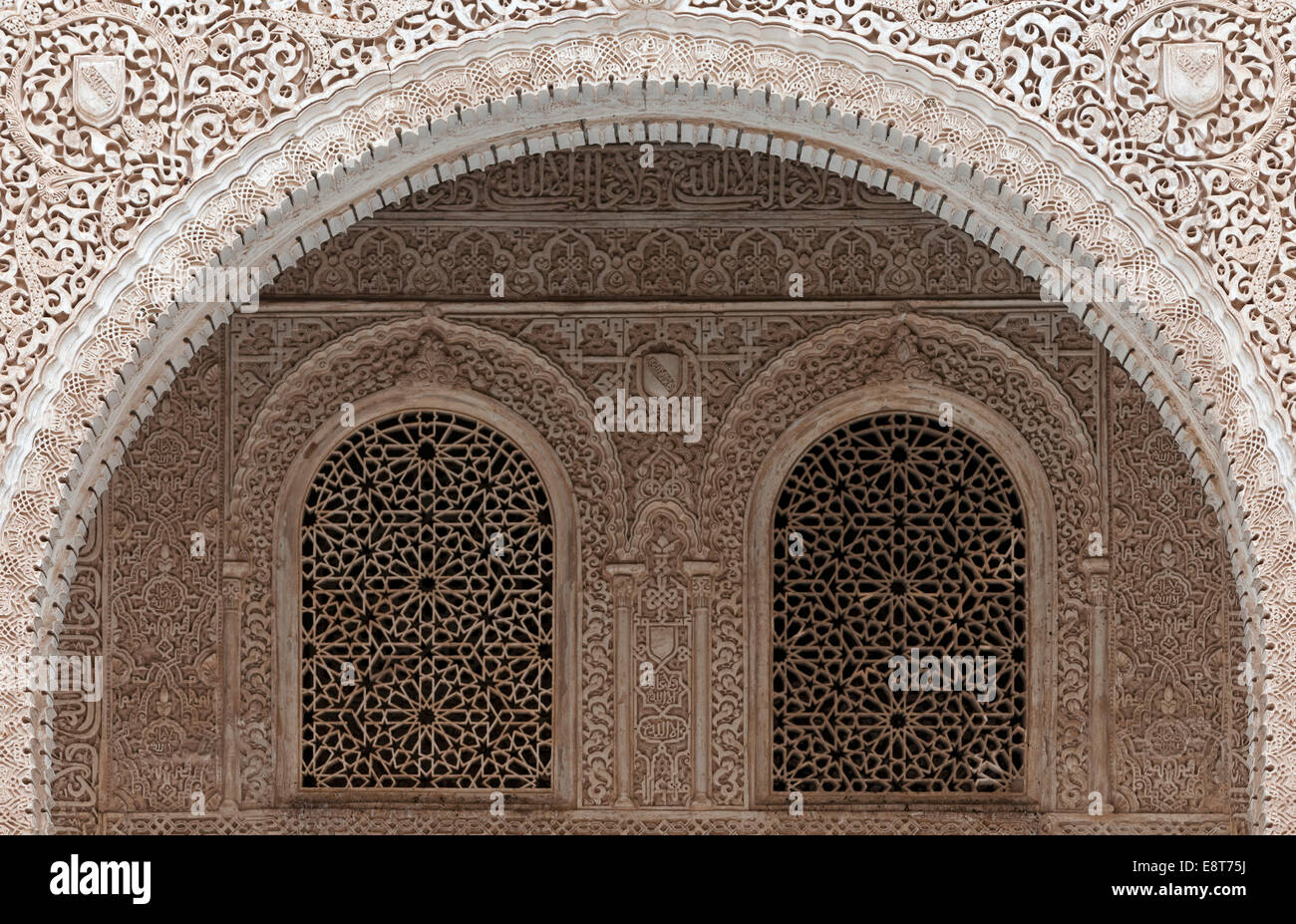 Ornate Moorish reliefs decorating the wall and the window arches in the ...