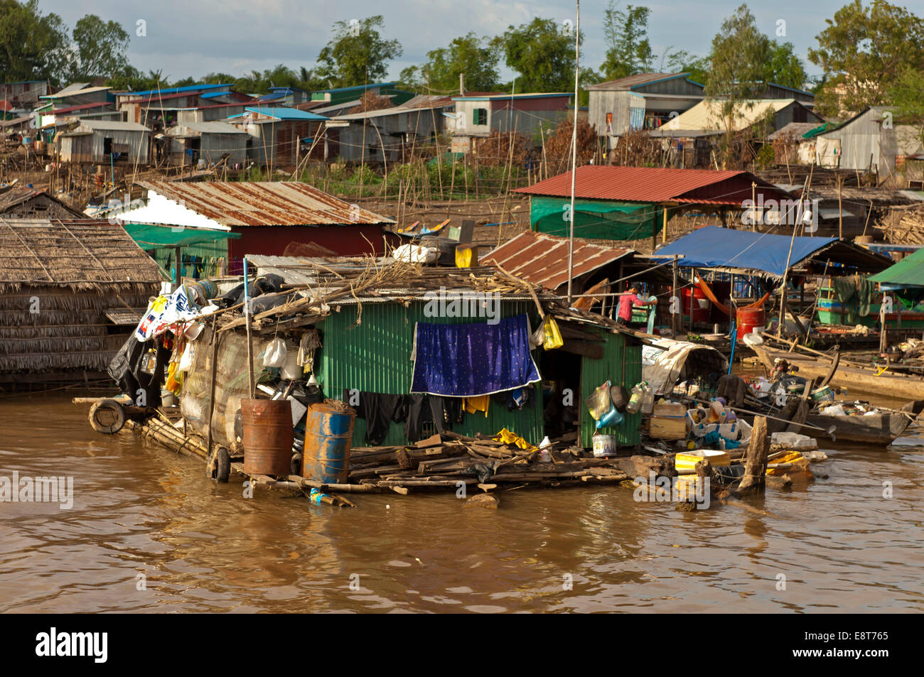 Huts of a floating slum, on the banks of the Mekong River near Phnom ...
