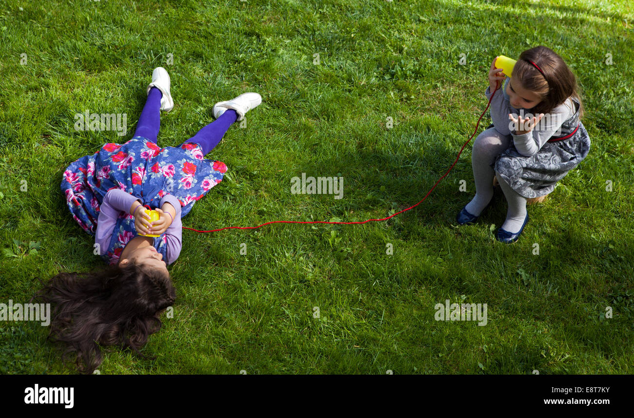 Two girls holding hands playing hi-res stock photography and images - Alamy