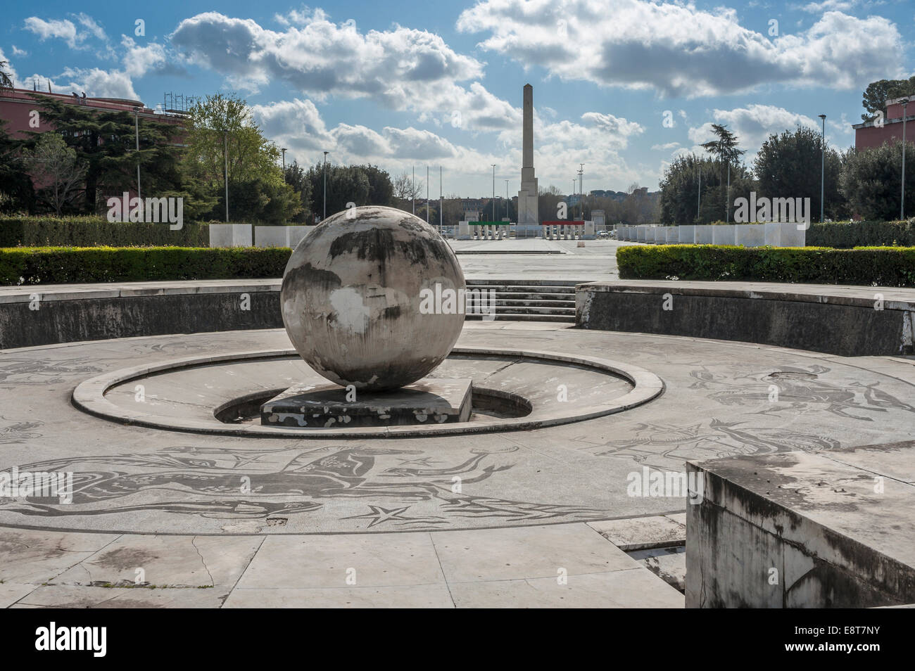 Stone globe and square with marble mosaics, behind Mussolini's obelisk ...