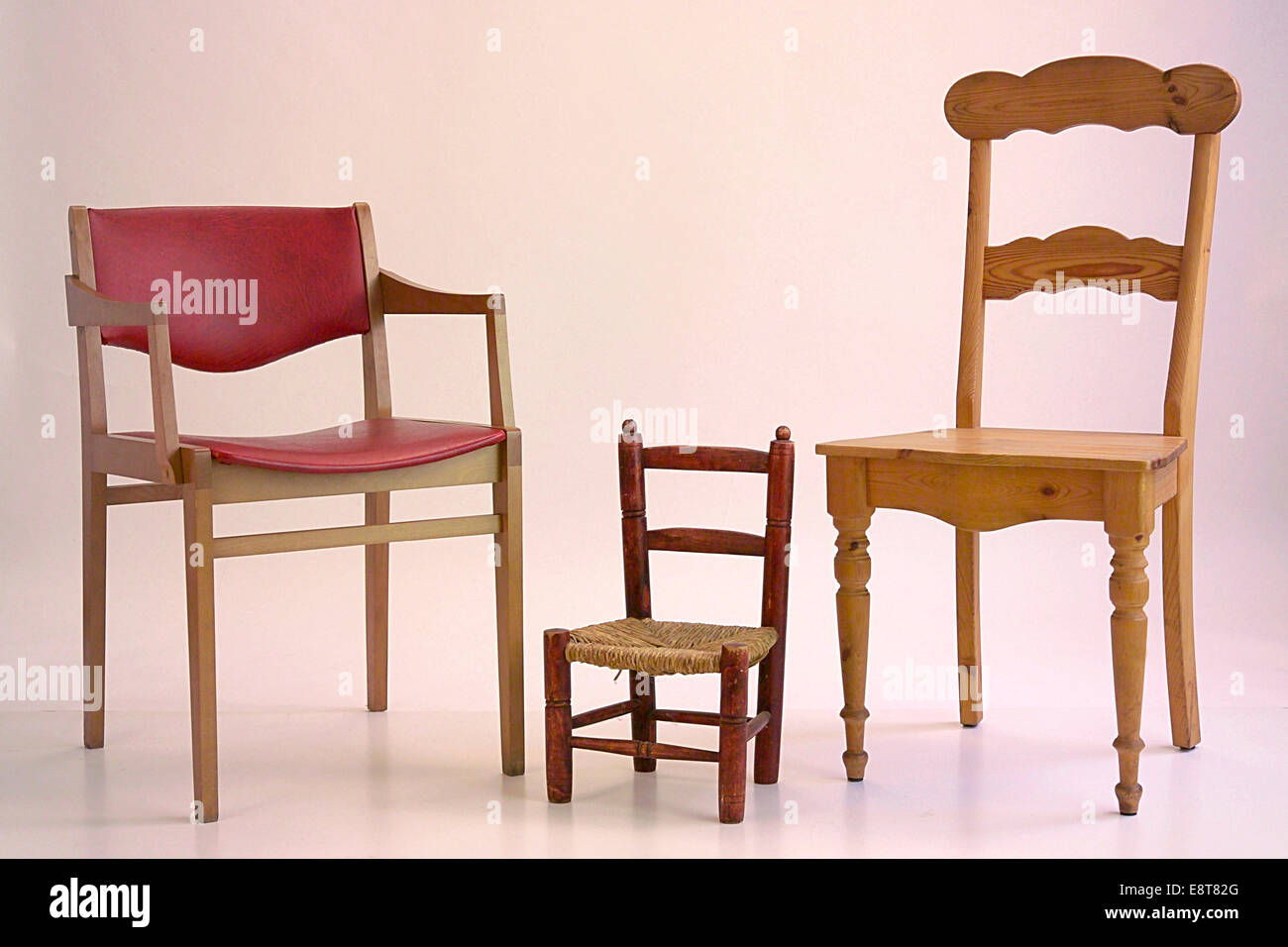 Two chairs and a children's chair Stock Photo - Alamy