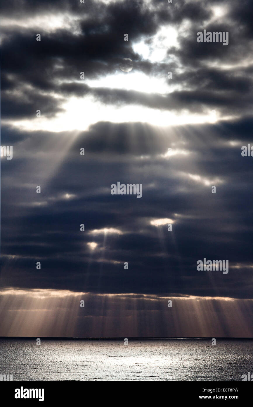 Sun rays through dark clouds hi-res stock photography and images - Alamy