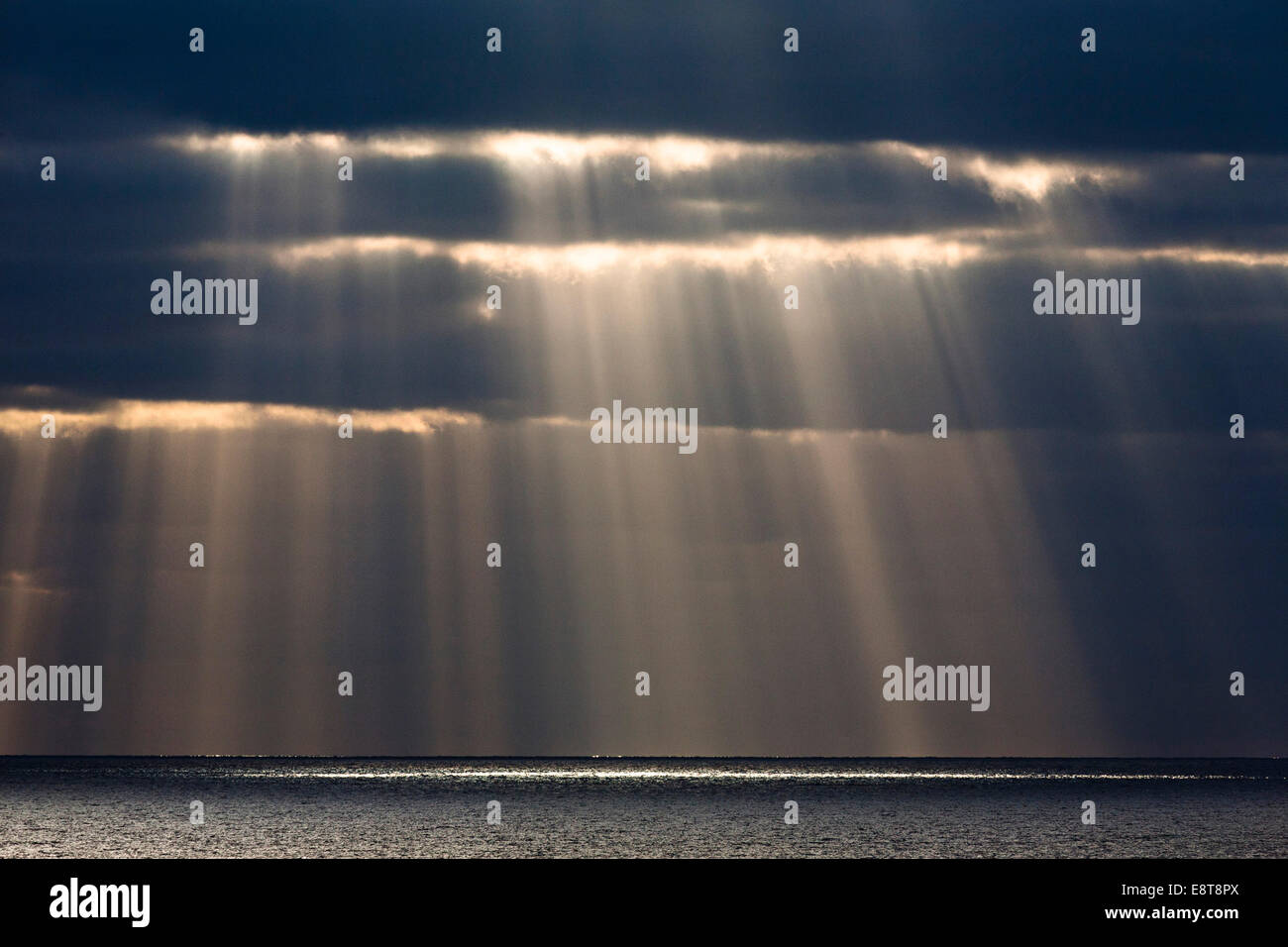 Sun rays through storm clouds hi-res stock photography and images - Alamy
