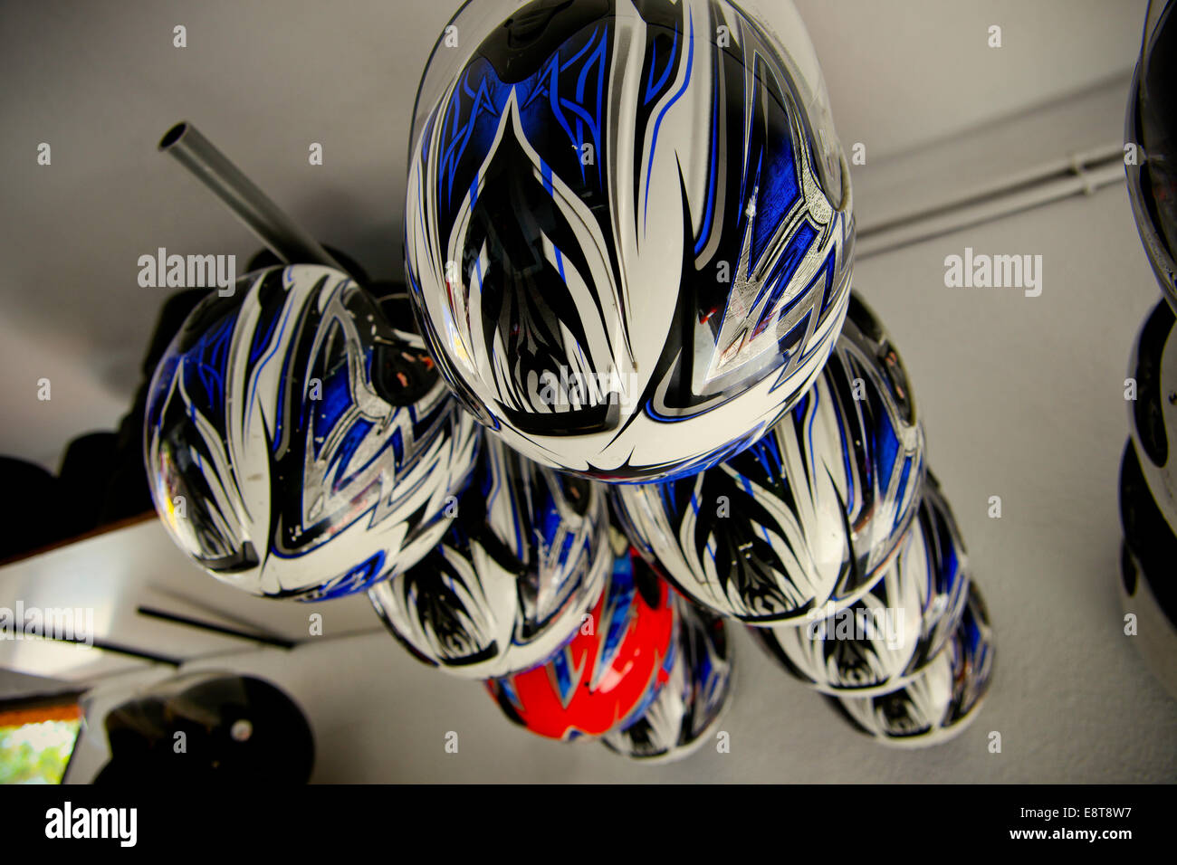 Go-Kart helmets hanging assorted. Karting circuit workshop Stock Photo ...