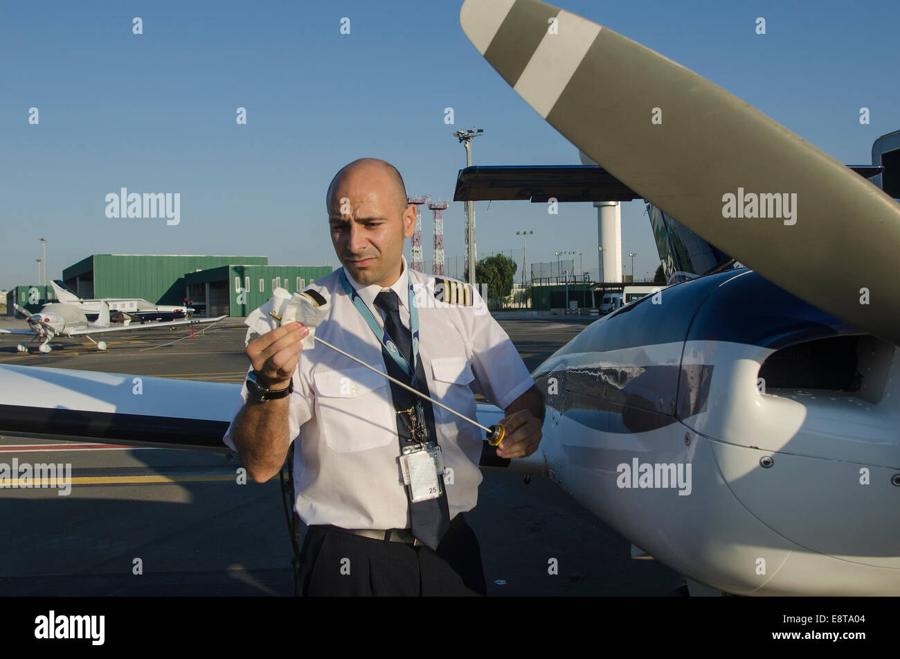 Pilot checking oil in airplane Stock Photo - Alamy