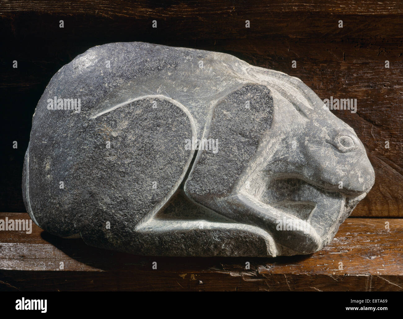 Modern stone carving of a frightened hare inside St Melangell's church ...