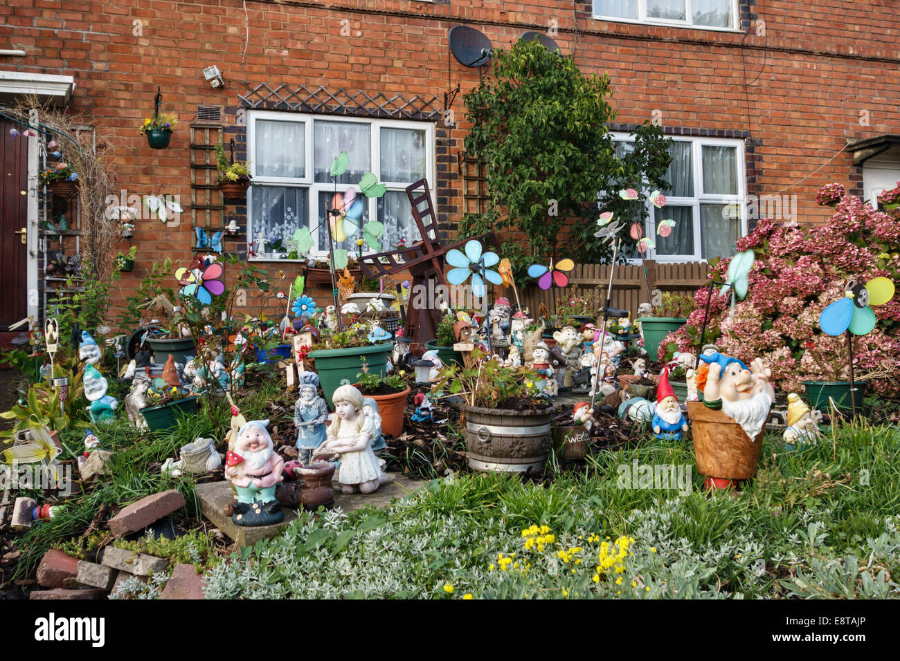 A collection of garden gnomes outside a terraced house, Worcester, UK ...