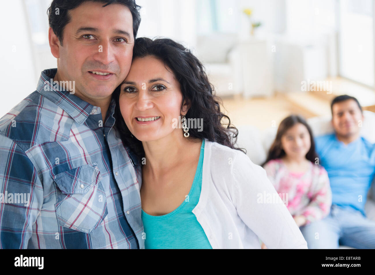 Hispanic family smiling together Stock Photo - Alamy