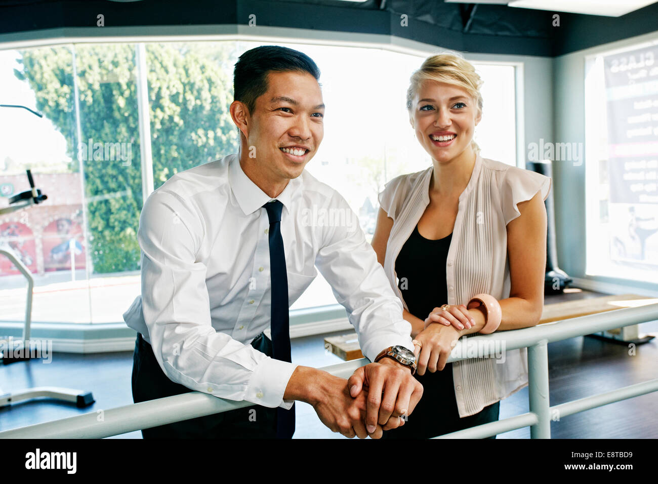 Business people talking at railing Stock Photo - Alamy