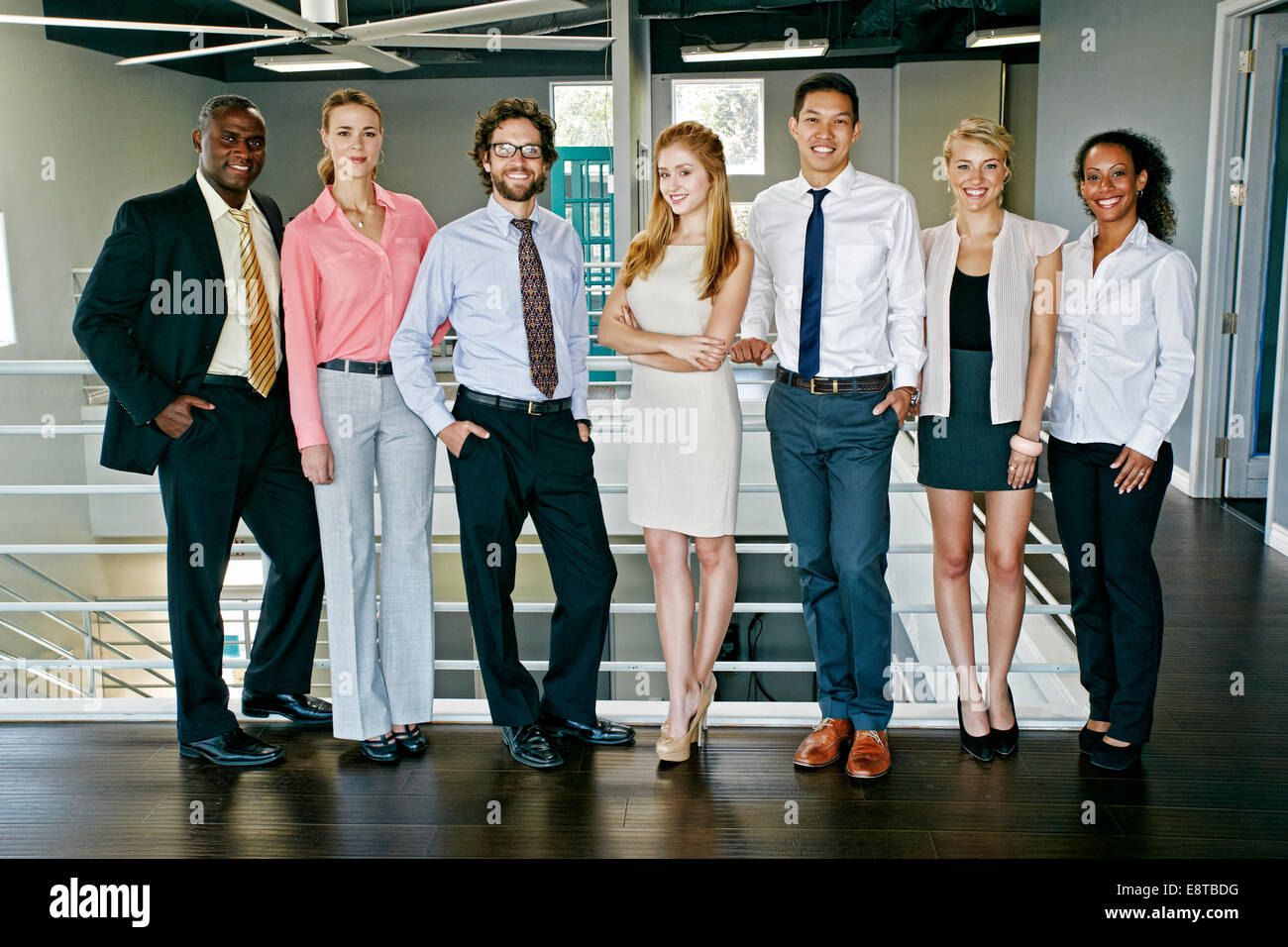 Business people smiling together near railing Stock Photo - Alamy
