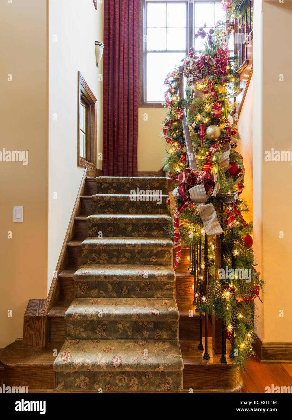 Banister decorated with boughs and string lights for Christmas Stock ...