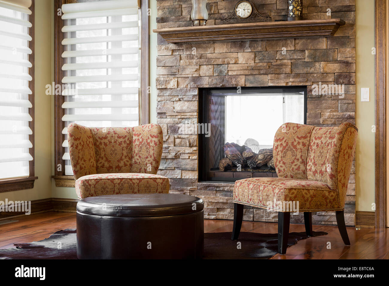 Chairs and fireplace in living room Stock Photo - Alamy