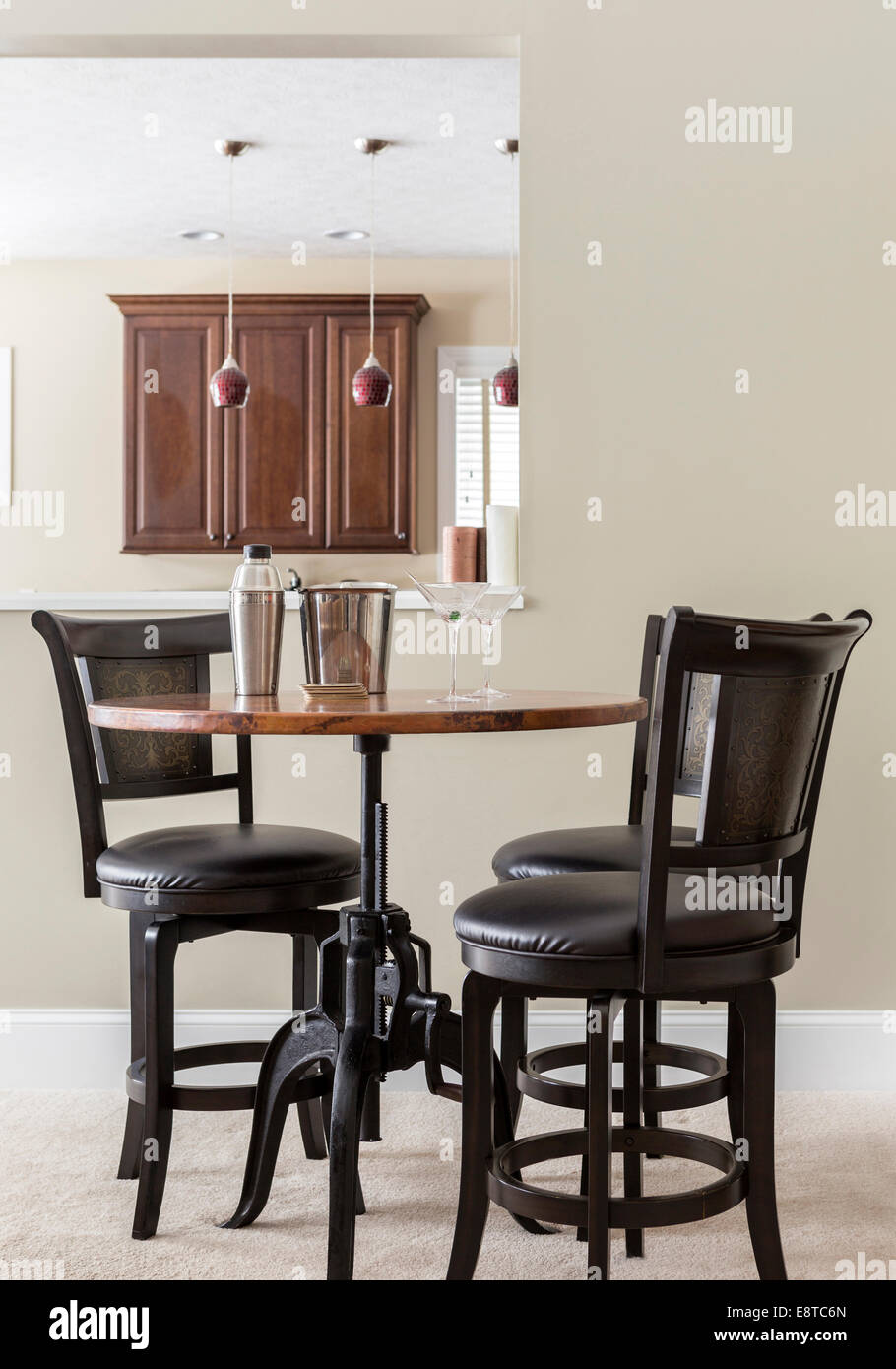 Cocktail glassware on table with stools Stock Photo - Alamy