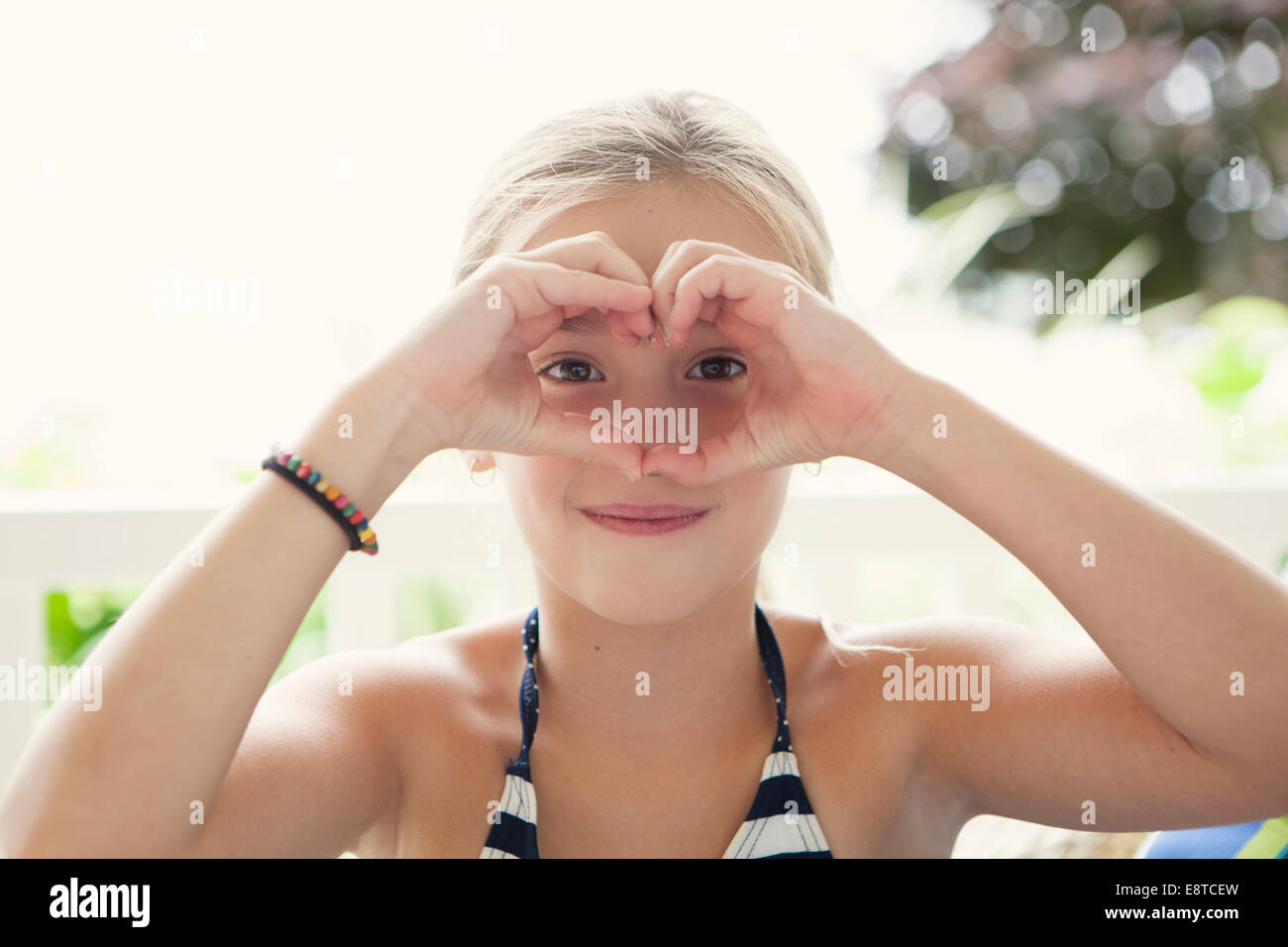 Caucasian girl making heart shape around eyes Stock Photo - Alamy