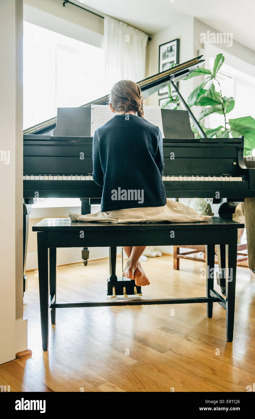 Girl playing piano back hi-res stock photography and images - Alamy