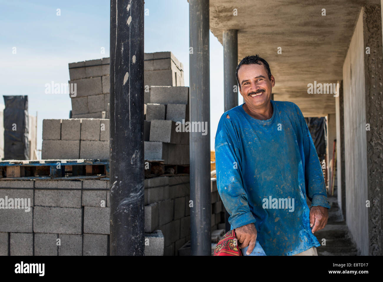 Hispanic construction worker smiling at construction site Stock Photo ...