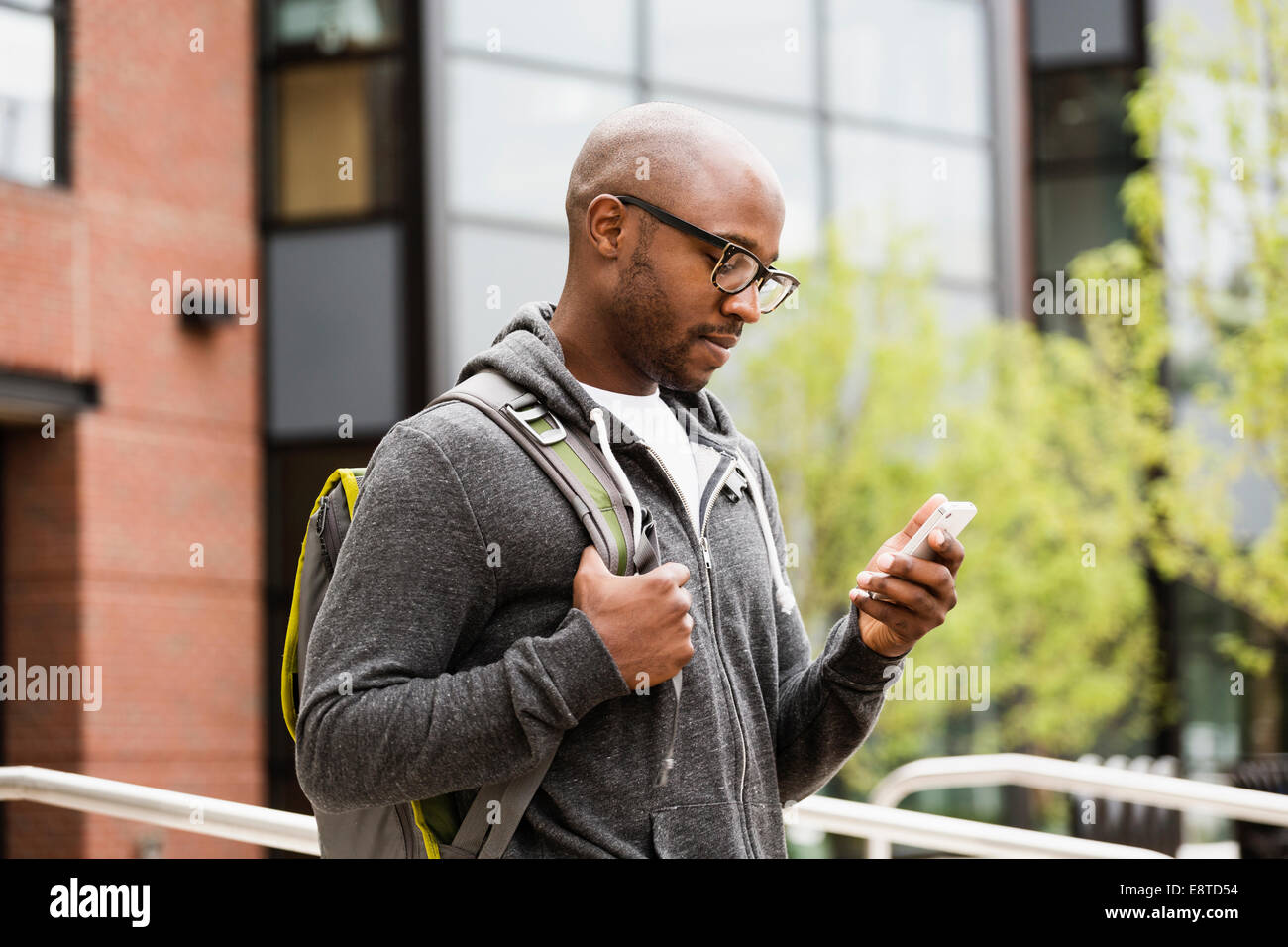 Black man using cell phone on city street Stock Photo - Alamy
