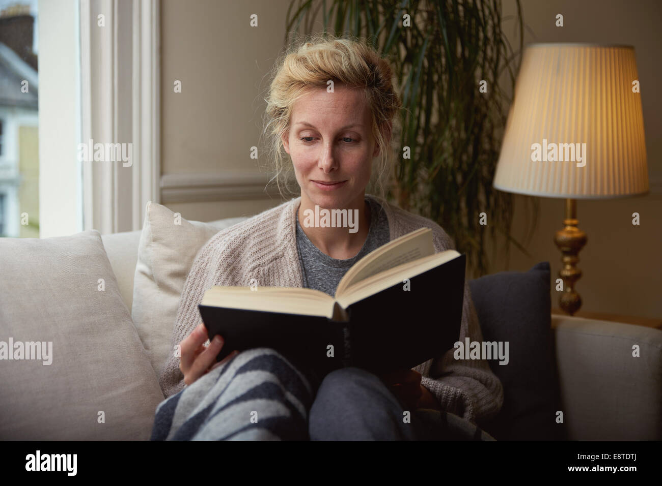 A woman reads a book Stock Photo - Alamy