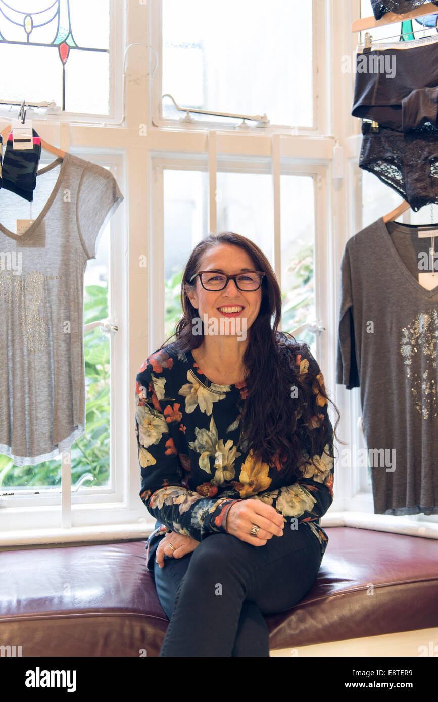 female, lady shopkeeper, saleswoman, in her clothes shot in Brighton ...