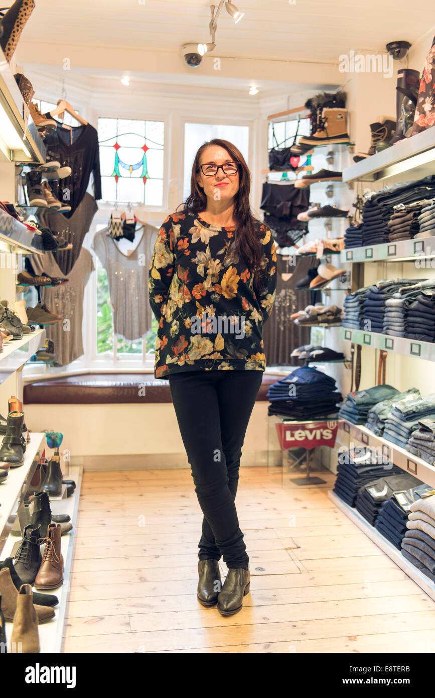 female, lady shopkeeper, saleswoman, in her clothes shot in Brighton ...