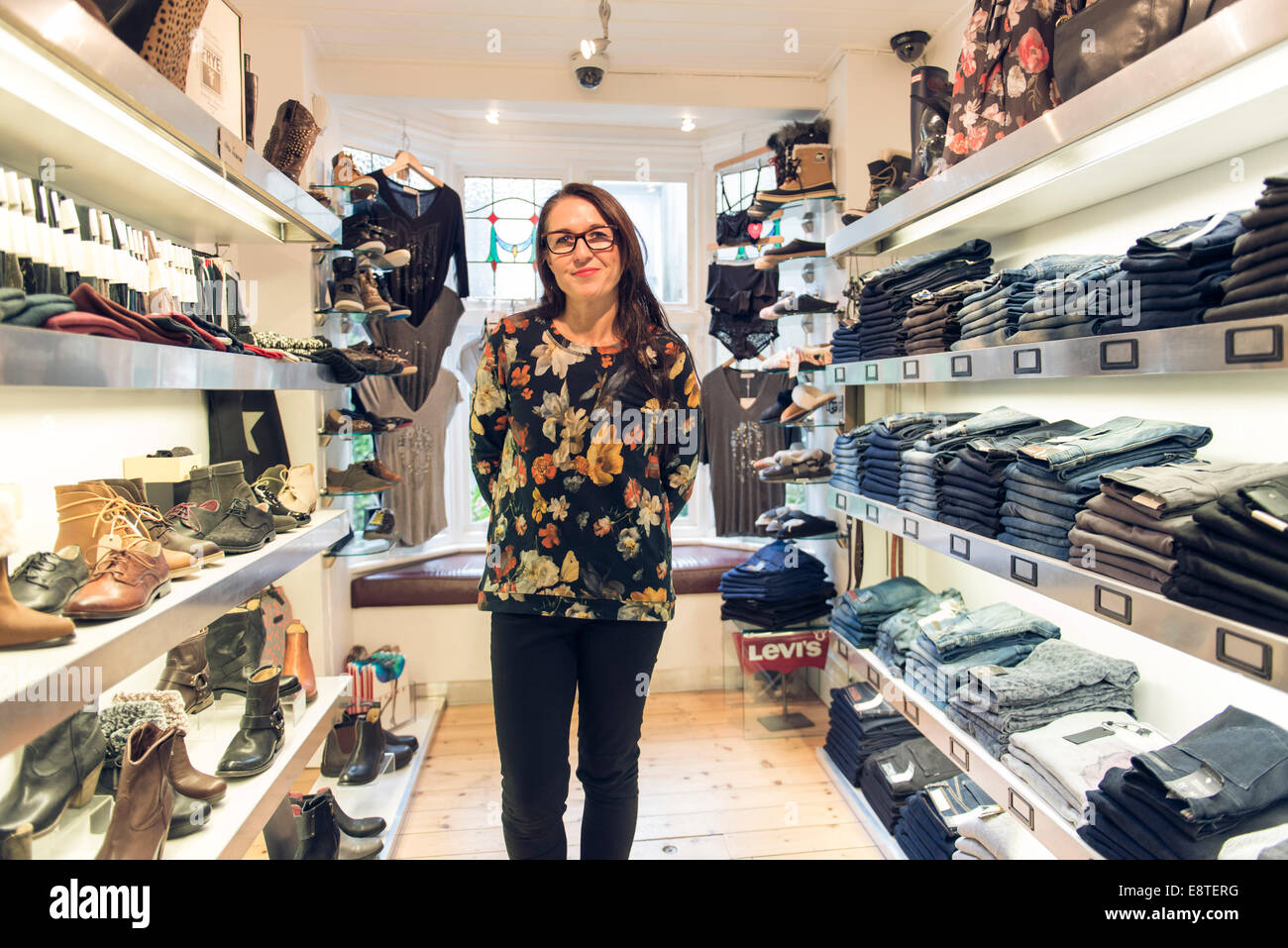 female, lady shopkeeper, saleswoman, in her clothes shot in Brighton ...