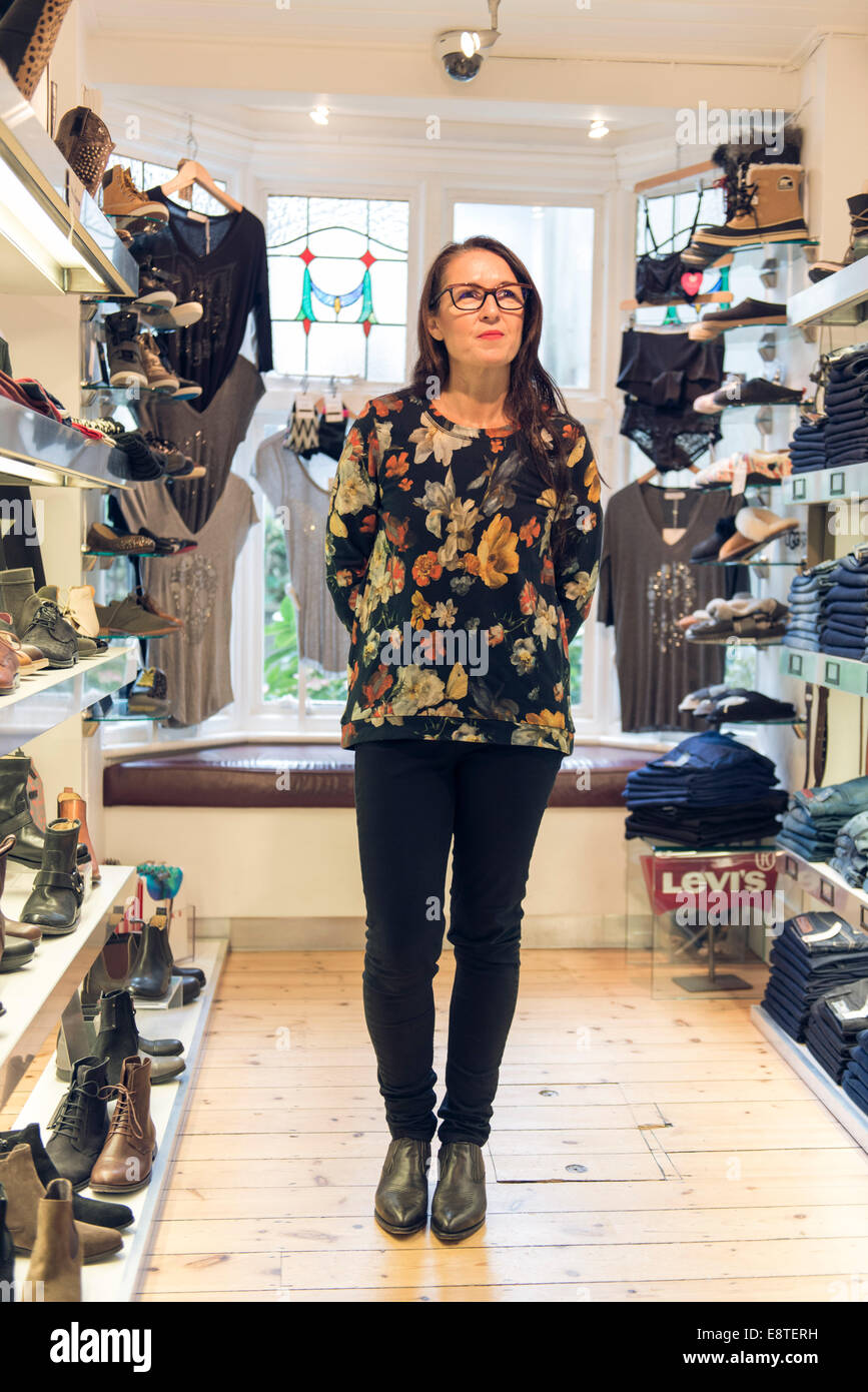 female, lady shopkeeper, saleswoman, in her clothes shot in Brighton ...