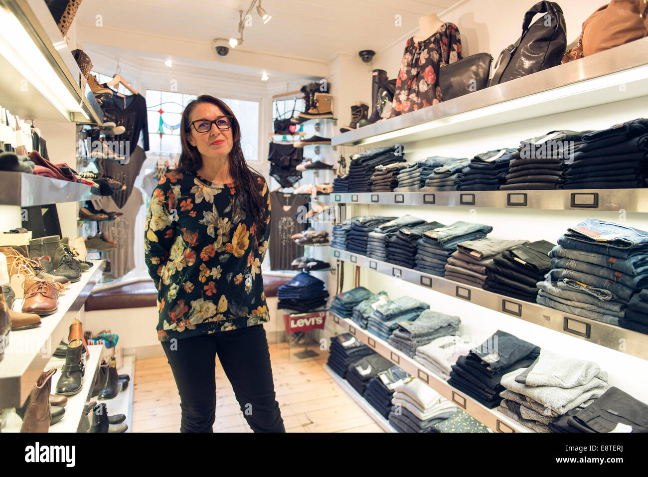 female, lady shopkeeper, saleswoman, in her clothes shot in Brighton ...