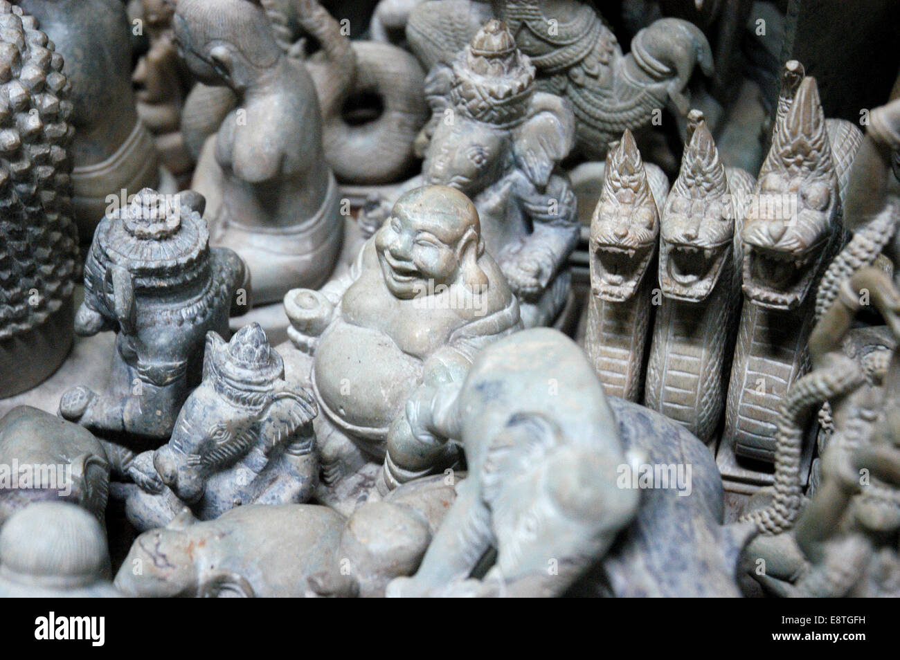 little stone statues on display in a market for sale Stock Photo - Alamy