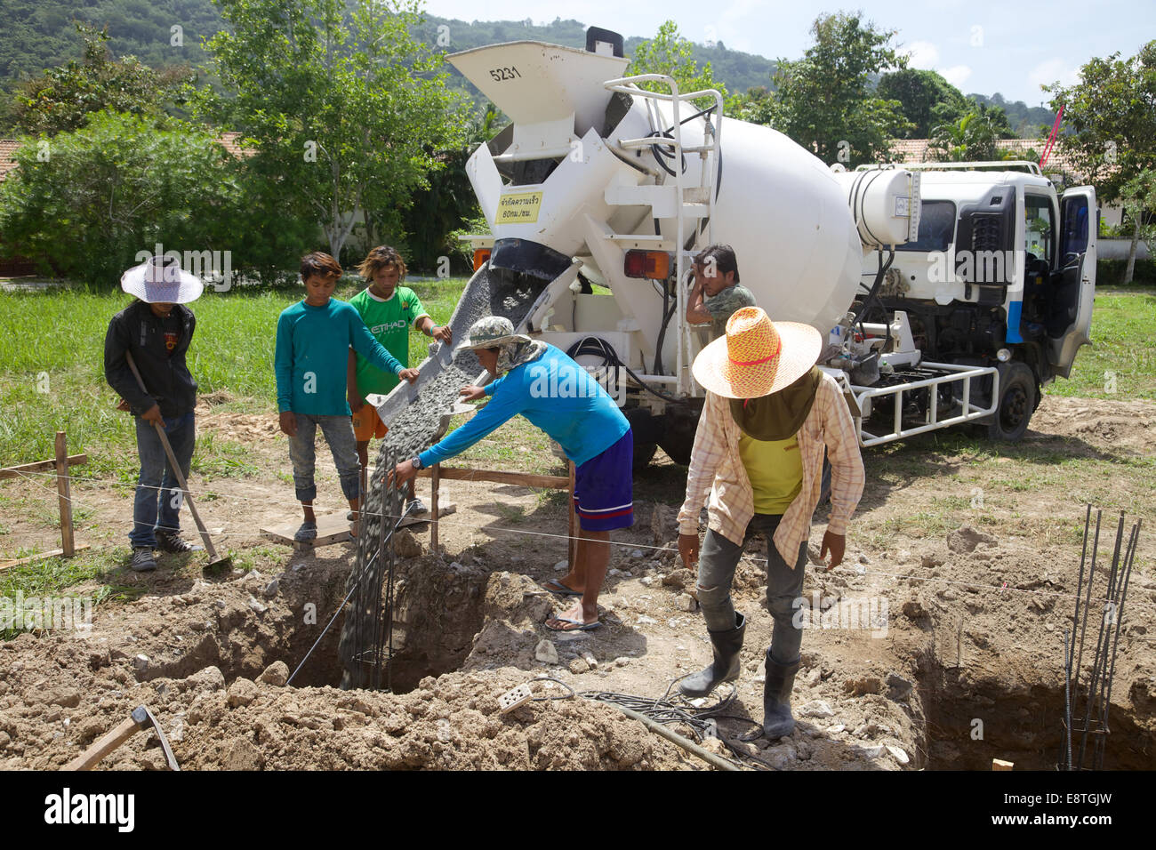 Burmese men working pouring cement, for a wall in Thailand Stock Photo ...