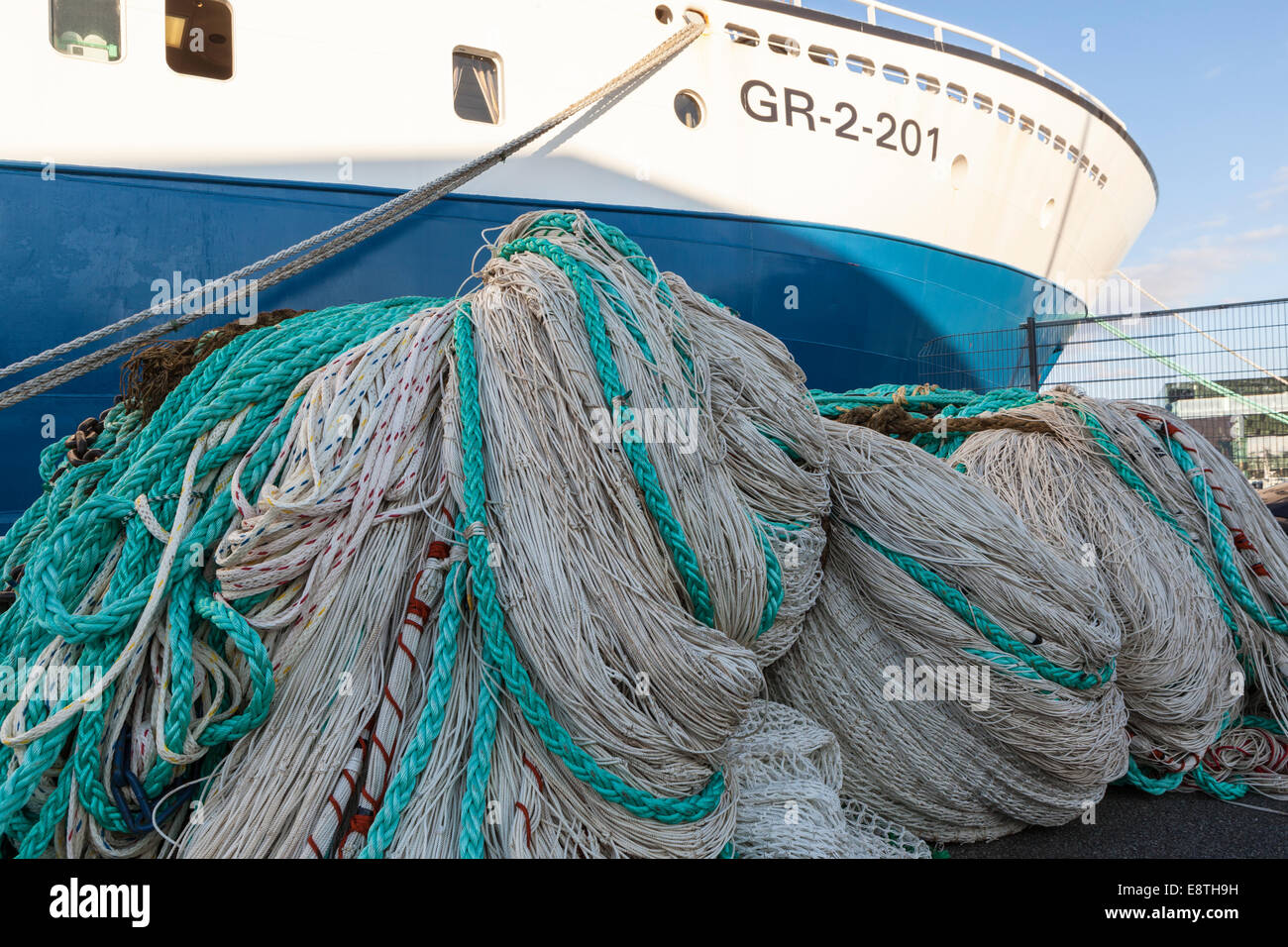 Fishing nets on quayside ready to loaded on board deep-sea trawler ...