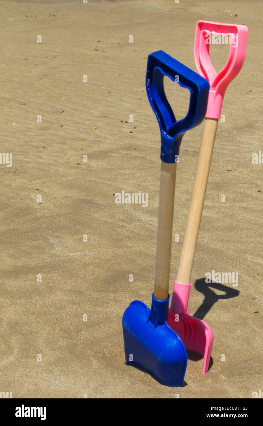 Children's spades on a sandy beach Stock Photo - Alamy