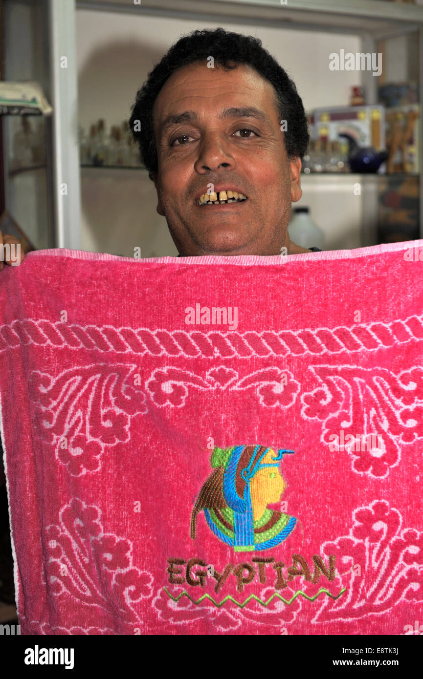 Egyptian shop keeper holding up a towel with Egyptian on it Stock Photo ...