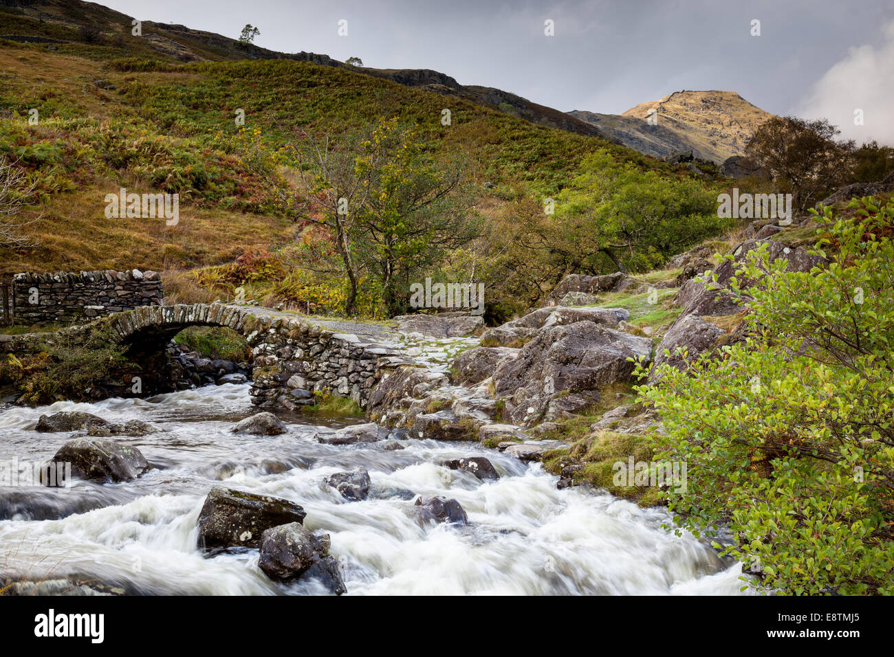 The Scandale Beck flowing under High Sweden Bridge, (with High Pike in ...