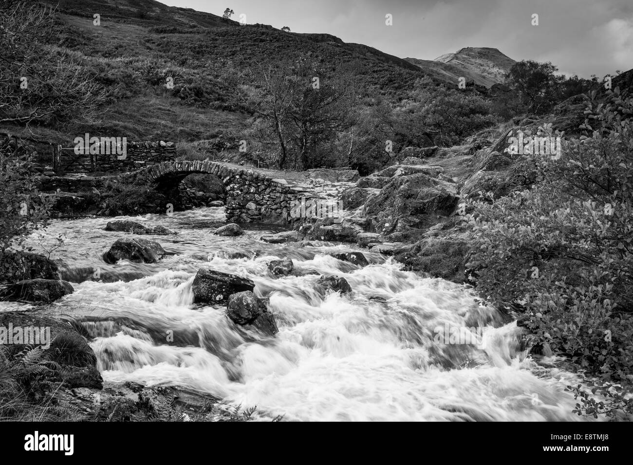 The Scandale Beck flowing under High Sweden Bridge, (with High Pike in ...