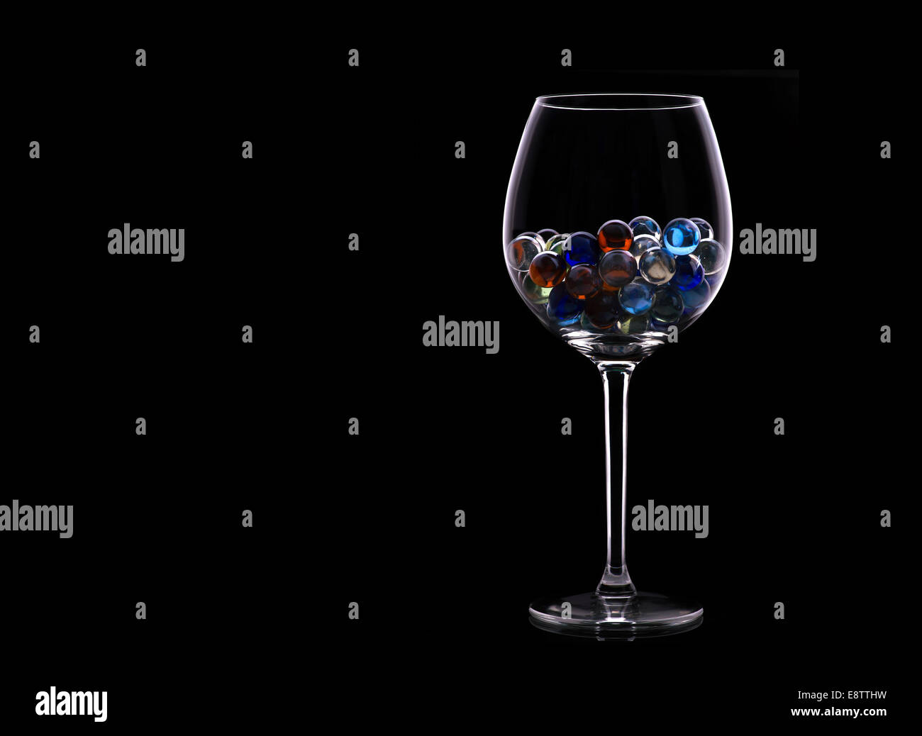 Small colored balls inside glass on the black background Stock Photo ...