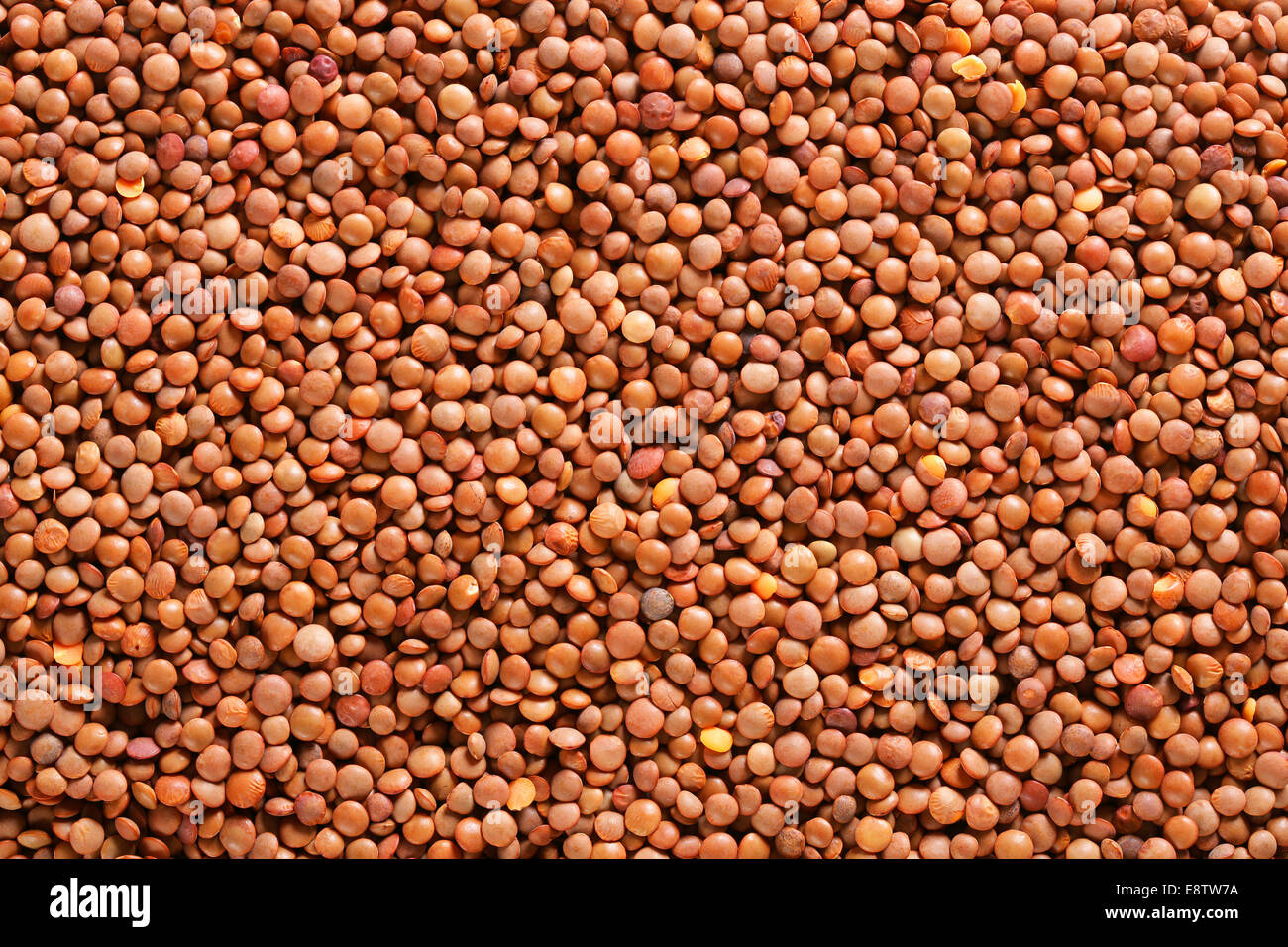 Raw whole red lentils - background Stock Photo - Alamy