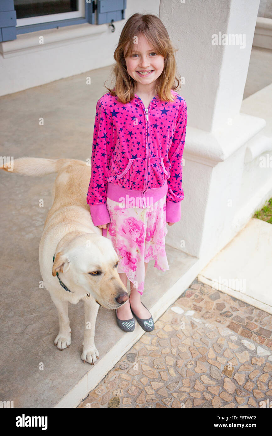 Young girl stands with her golden Labrador dog Stock Photo - Alamy