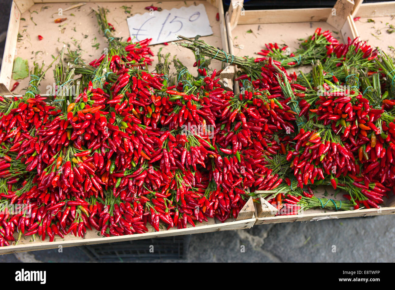 Bunches of red chilli peppers for sale from a street market stall in ...