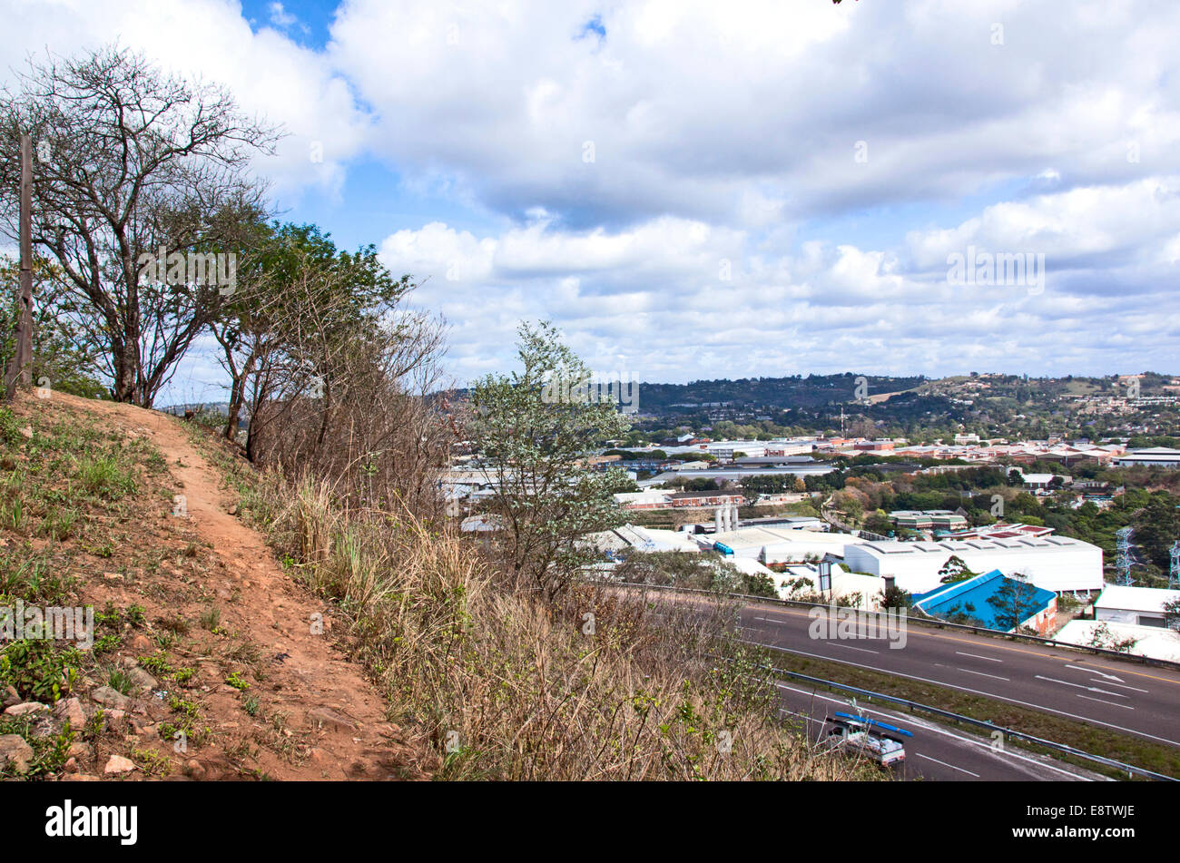 Footpath beside freeway passing built-up industrial area in Pinetown in ...