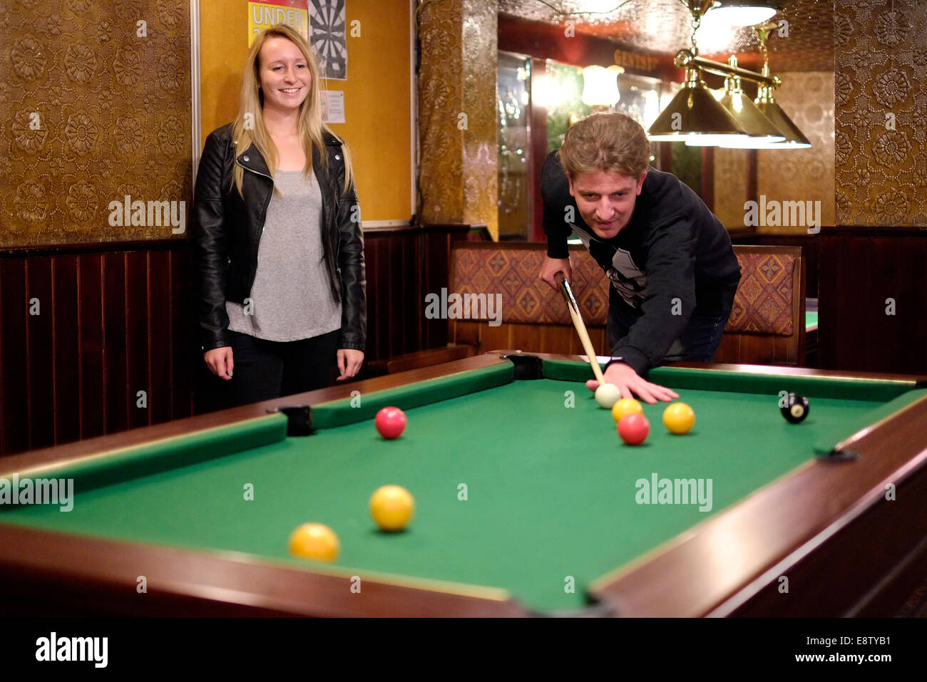 young couple playing pool in a traditional british pub the eldon arms ...