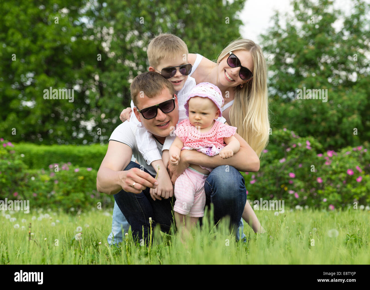 Portrait Of Happy Family In Garden Stock Photo - Alamy