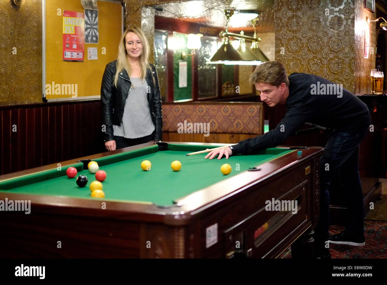 young couple playing pool in a traditional british pub the eldon arms ...