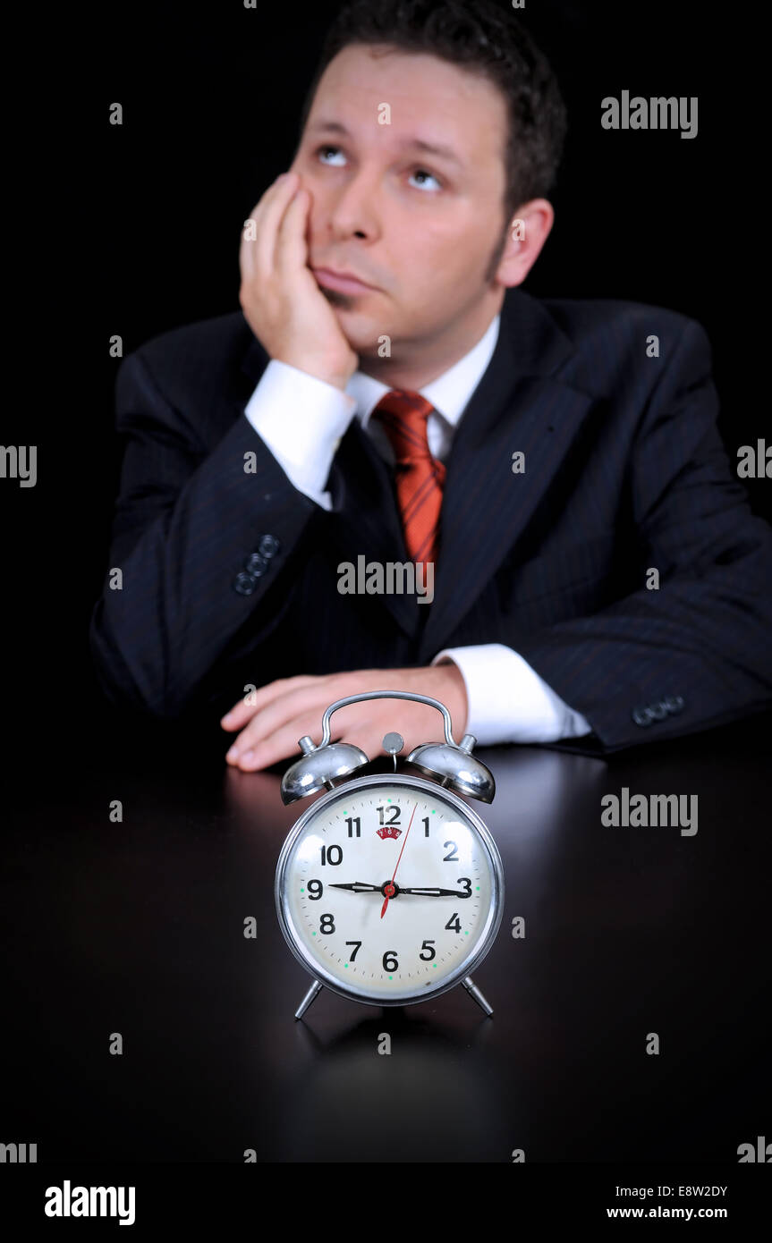Businessman is wasting time concept on the black background Stock Photo ...