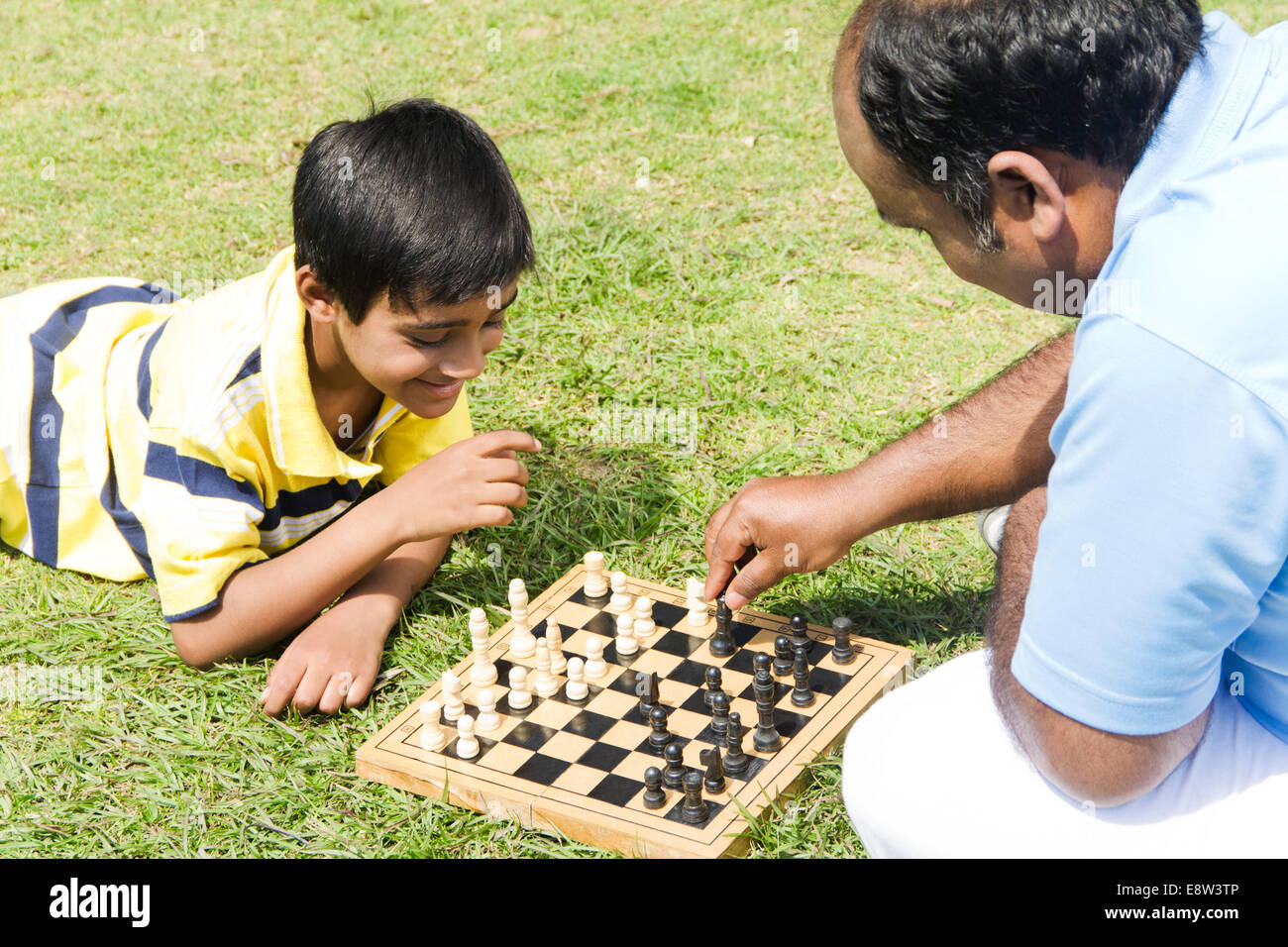 1 Indian Man Playing Chess with Kid Stock Photo - Alamy
