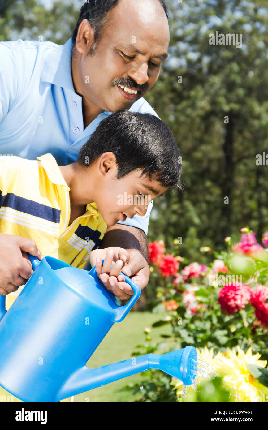 1 Indian Man Spraying Water with kid Stock Photo - Alamy