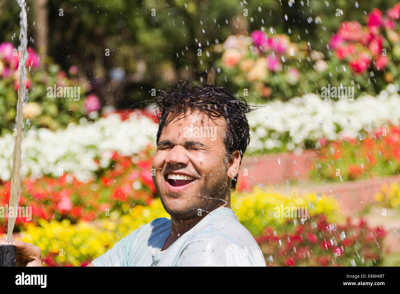 1 Indian Man Spraying Water and Bathing Stock Photo - Alamy