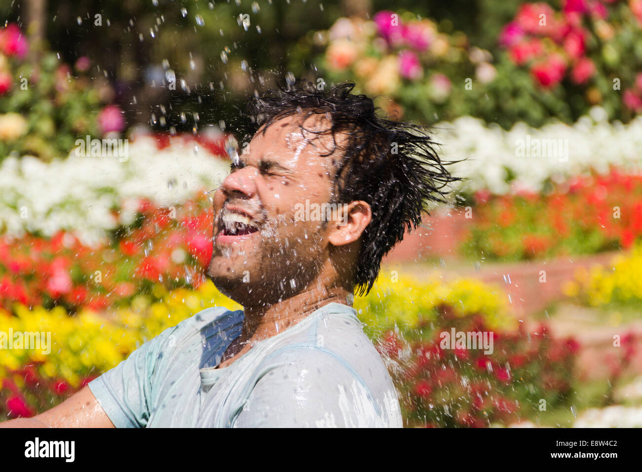 1 Indian Man Spraying Water and Bathing Stock Photo - Alamy
