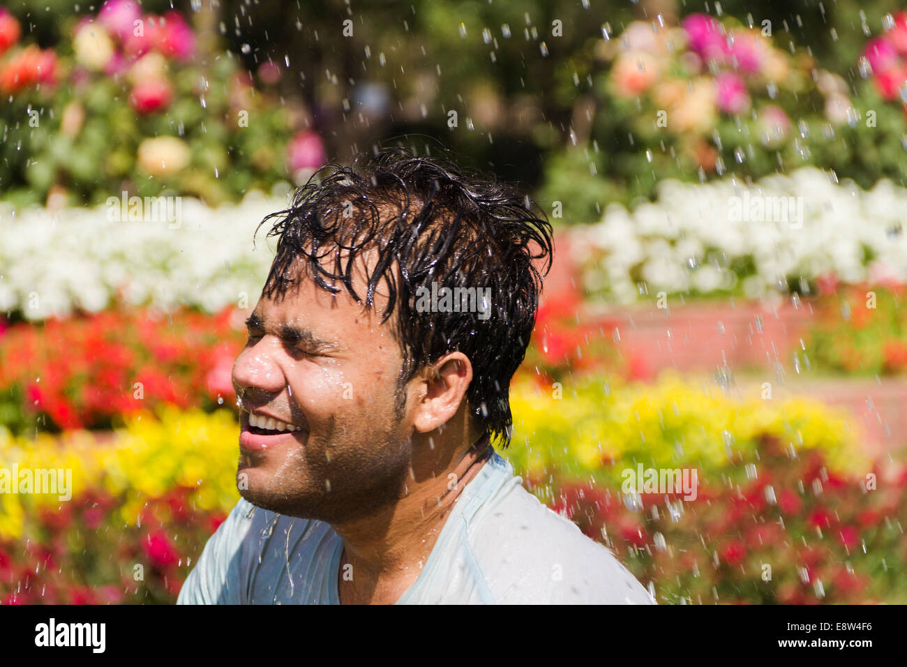 1 Indian Man Spraying Water and Bathing Stock Photo - Alamy